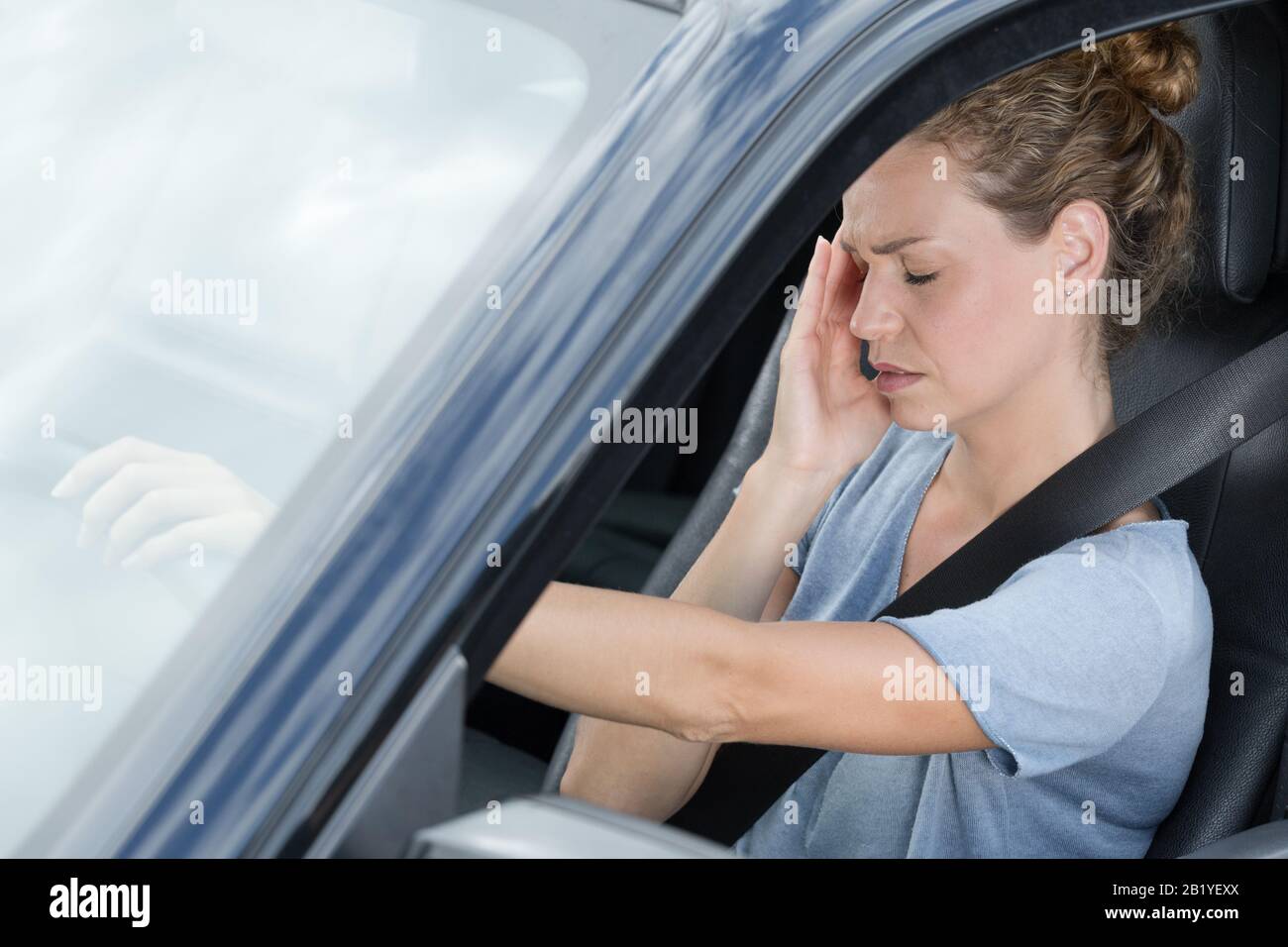 woman having headache after driving car in traffic jam Stock Photo - Alamy