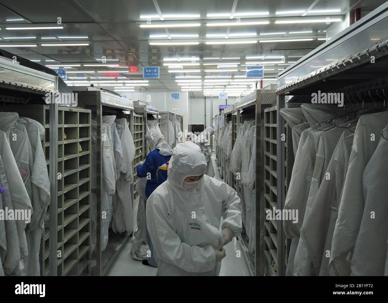 Chinese workers put on dust-proof clothing before entering the work ...