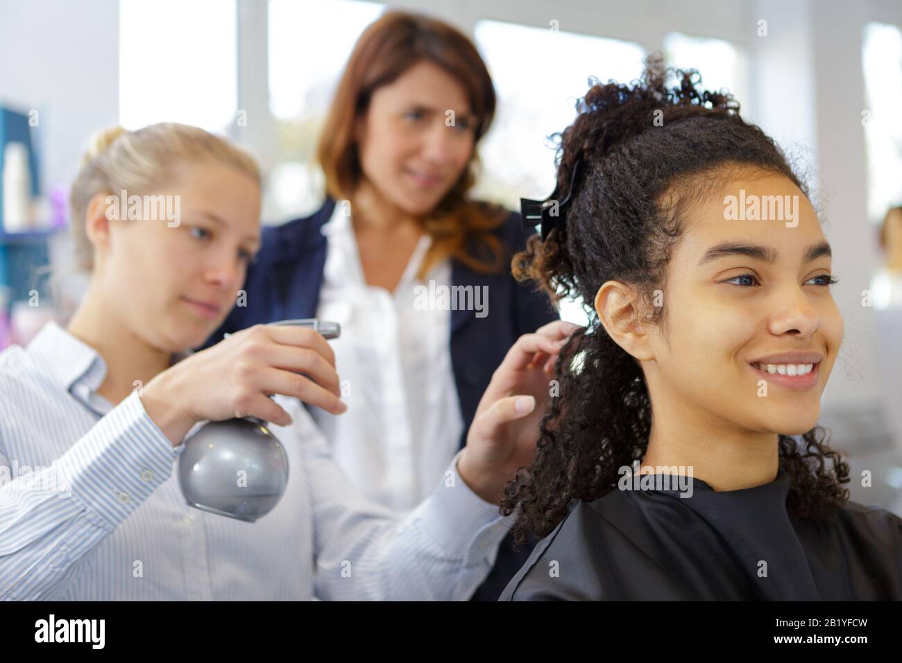 Woman spraying hairspray hi-res stock photography and images - Alamy