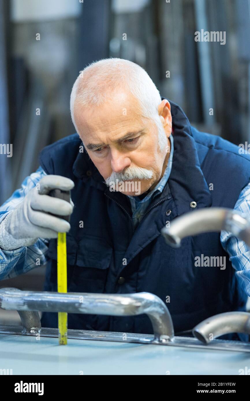 elderly engineer with a measuring tool Stock Photo - Alamy