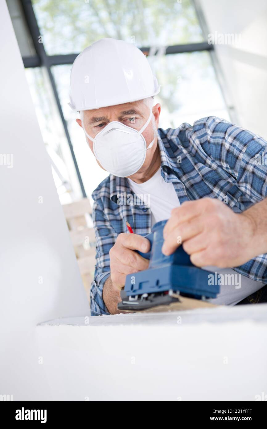 man sanding the wall Stock Photo - Alamy
