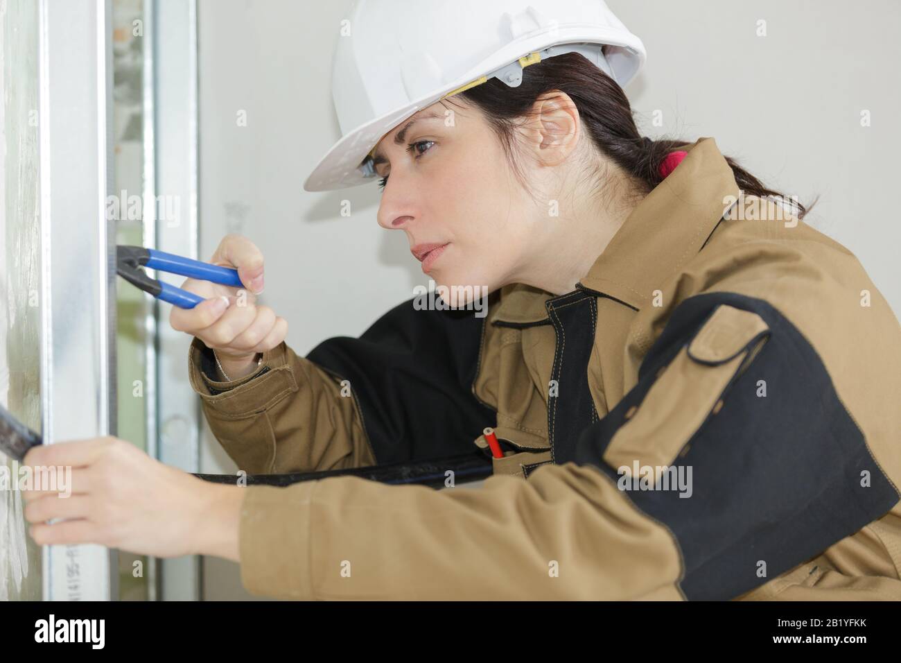 beautiful woman installing window at contruction site Stock Photo - Alamy