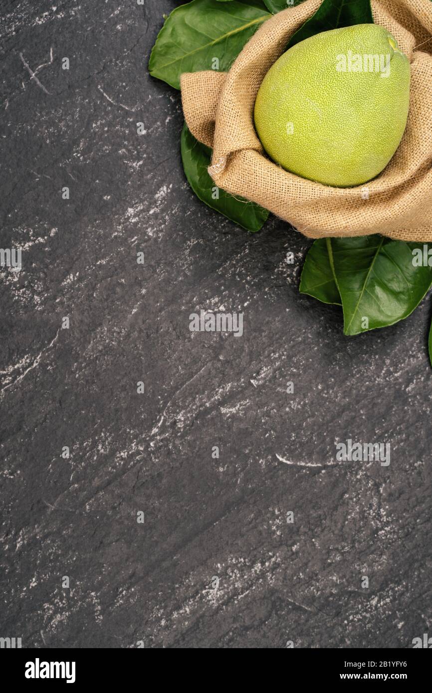 Fresh peeled pomelo, pummelo, grapefruit, shaddock on dark background ...