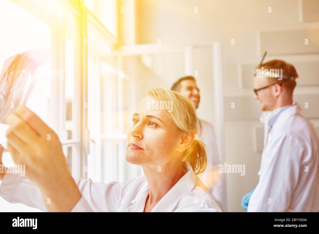 Group of doctors works in the hospital and looks at an x-ray Stock ...
