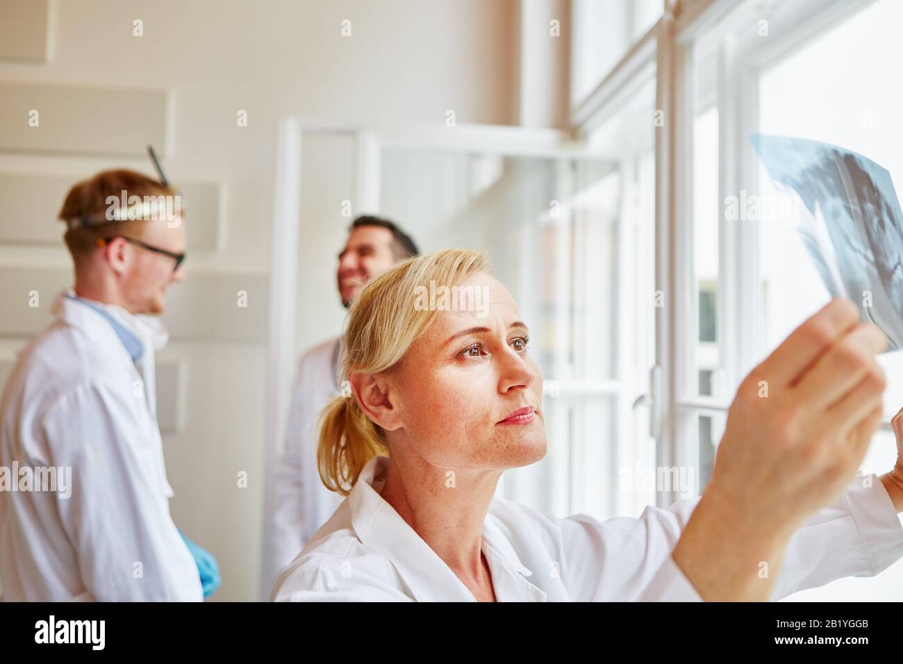 Group of doctors works in the hospital and looks at an x-ray Stock ...