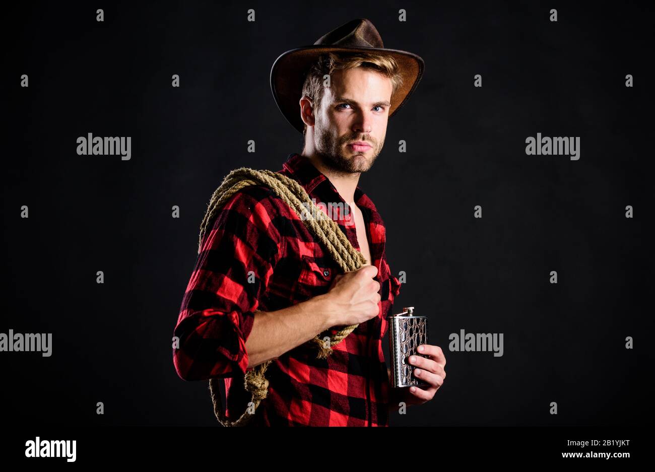 Brutal cowboy drinking alcohol. Western culture. Man handsome unshaven ...