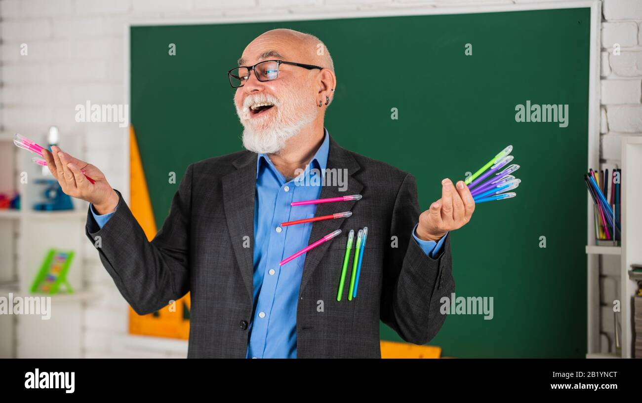 Senior intelligent man teacher at chalkboard. Education goals. School ...