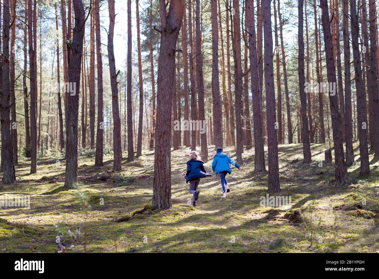 Two girls running through forest hi-res stock photography and images ...