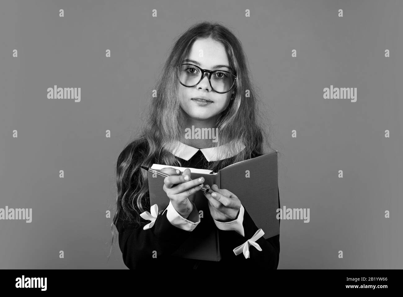 Always beautiful and smart every moment. Smart girl hold book and pen ...