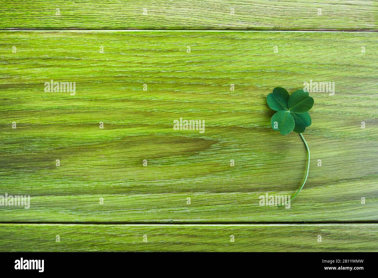 Leave clover on green wooden background. Greeting happy Four leaf ...