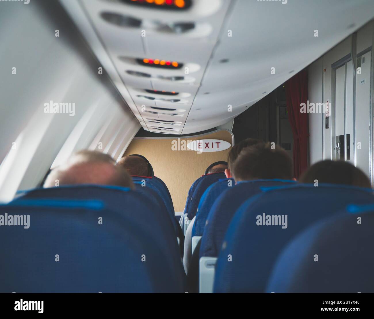 Interior inside of the plane with passengers Stock Photo - Alamy