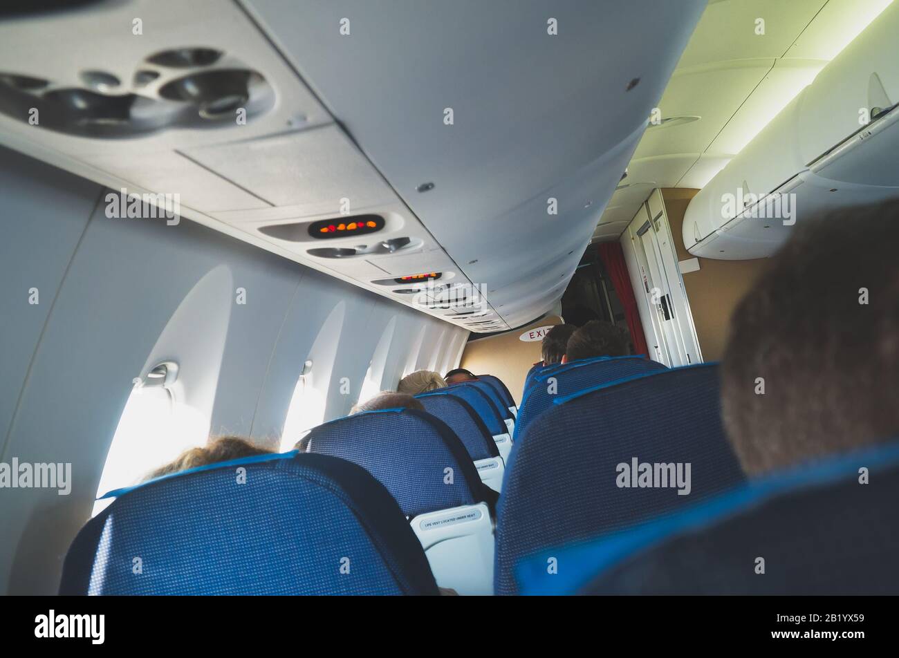 Interior inside of the plane with passengers Stock Photo - Alamy