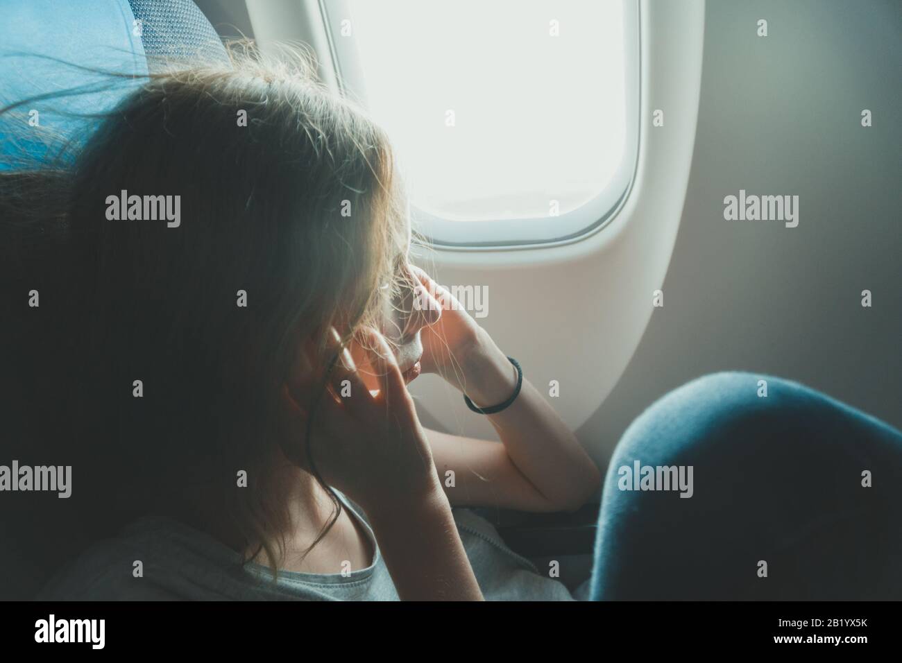 Little girl having ear pop on the airplane while taking off Stock Photo ...