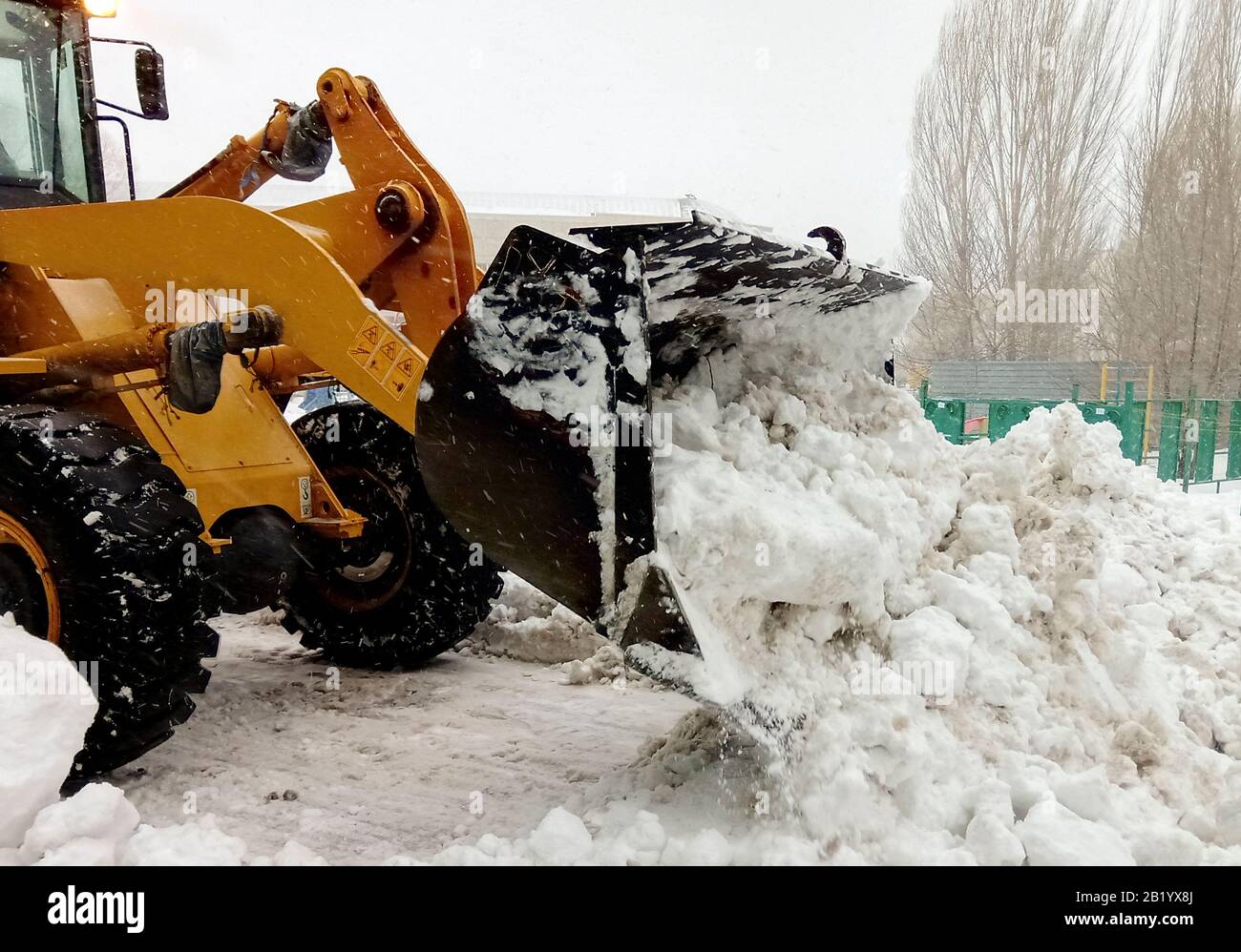 Big machine cleaning the snow from the road Stock Photo - Alamy