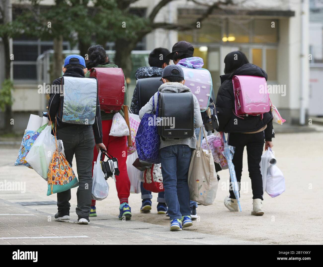 Tokyo, Japan. 28th Feb, 2020. Pupils leave an elementary school in ...