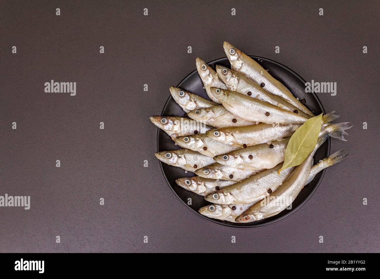 Raw sea fish smelt, sardines, anchovies, capelin with the scent of ...