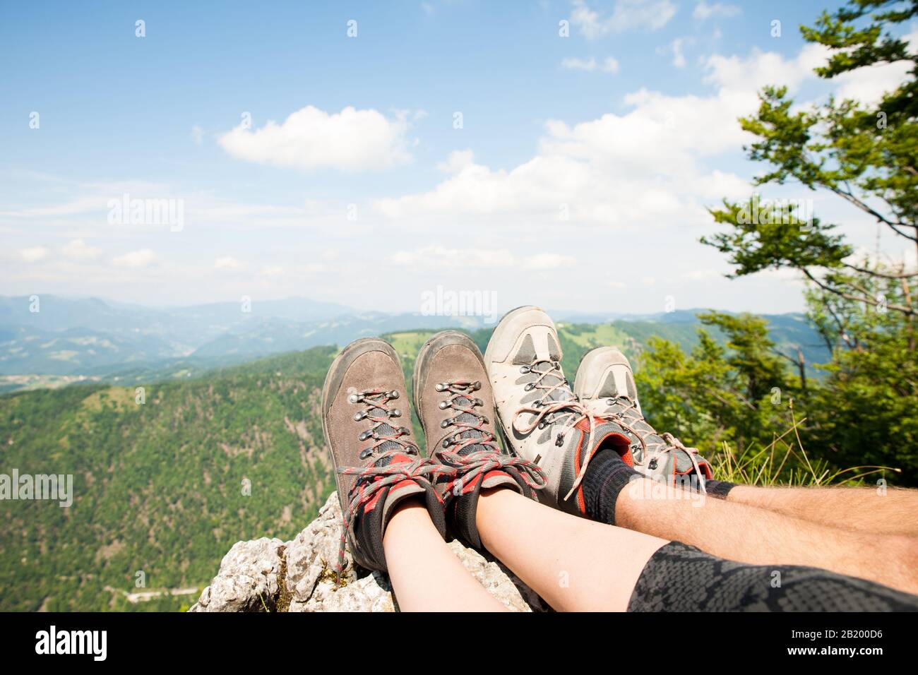 Mountain view over women legs as she rests on mountain peak Stock Photo ...