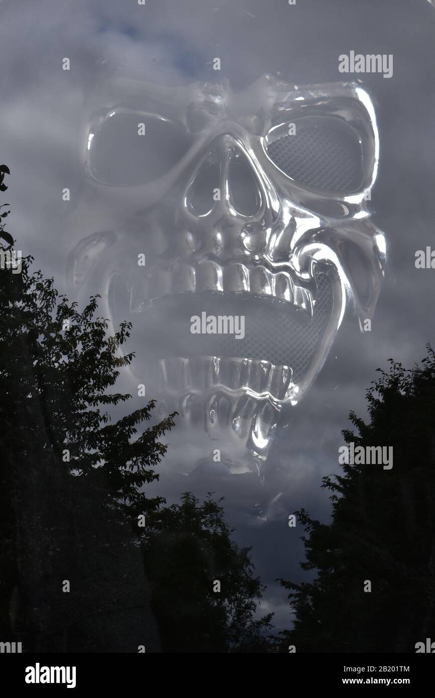 Death head skull mask double exposure against a cloudy sky Stock Photo ...