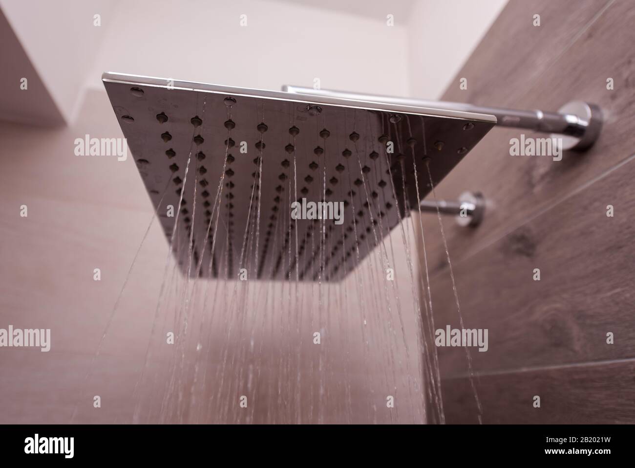 Modern elegant stainless steel shower with water drops in bath interior ...