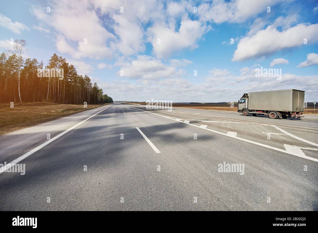 One track lorry moving on highway in brigth sunny day Stock Photo - Alamy