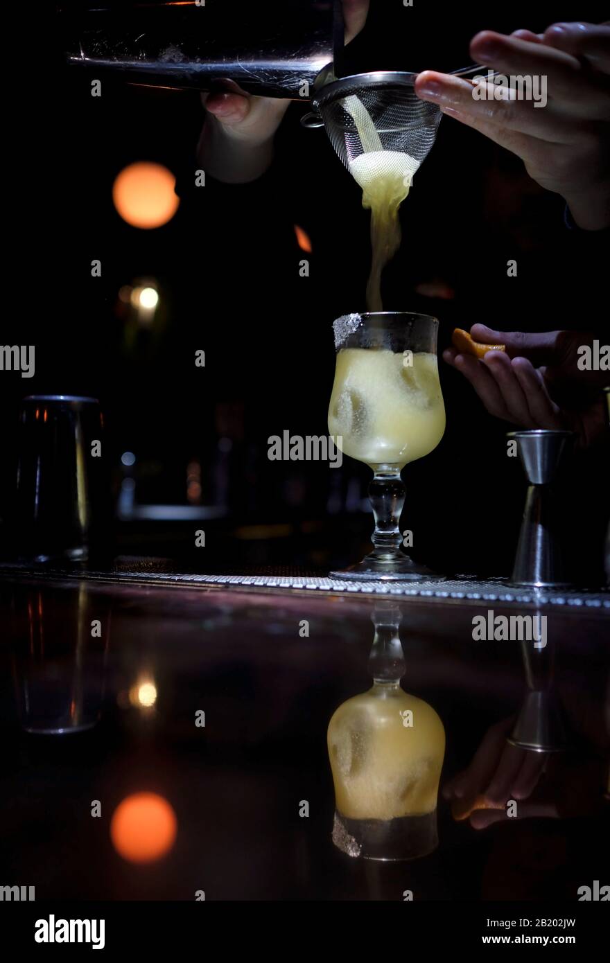 Bartender mixing a delicious looking cocktail in a bar Stock Photo - Alamy