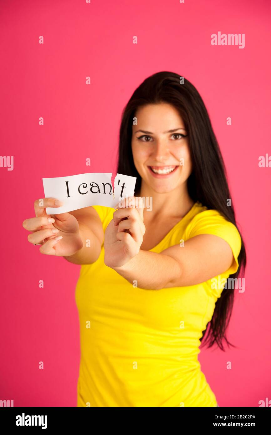 active young woman tearing apart text I can't Stock Photo - Alamy