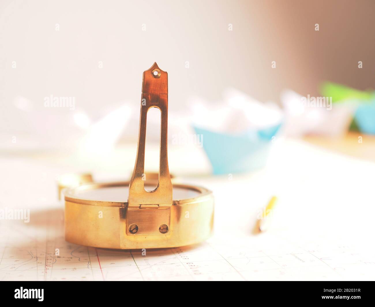 Close up of a compass and location marking with a red pin on sea map ...