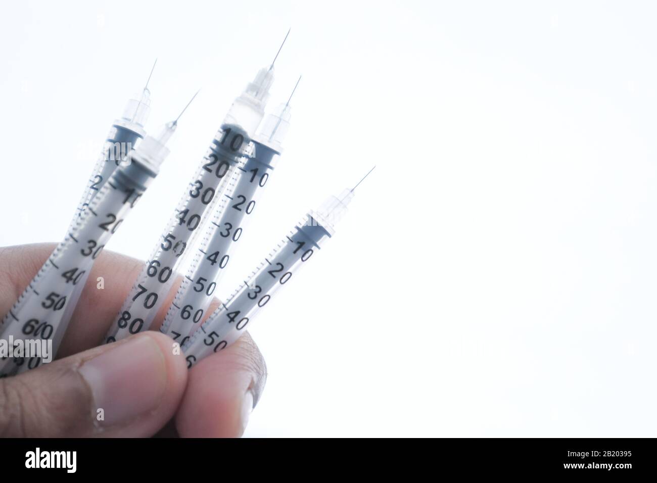 Close up of person hand holding syringe isolated on white Stock Photo ...