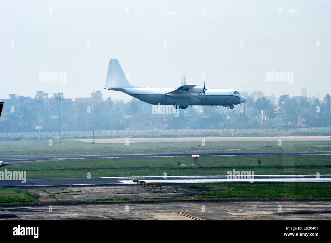 Side view of airplane landing on airport runway Stock Photo - Alamy