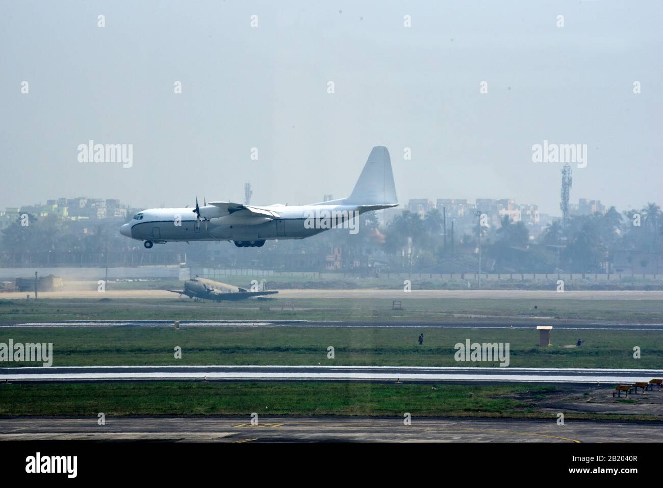 Side view of airplane landing on airport runway Stock Photo - Alamy
