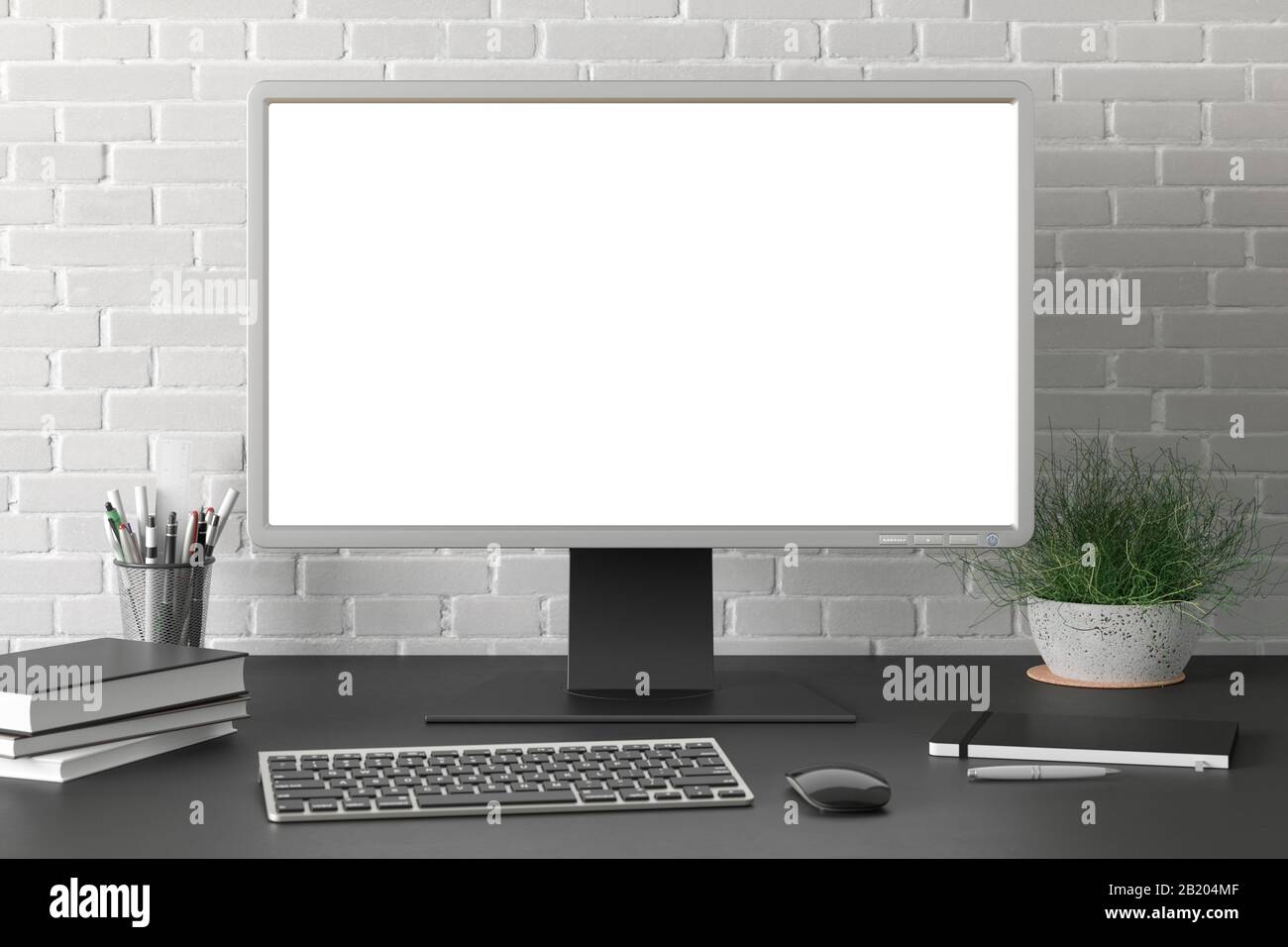 Workspace with blank computer monitor white screen mock up on the black ...