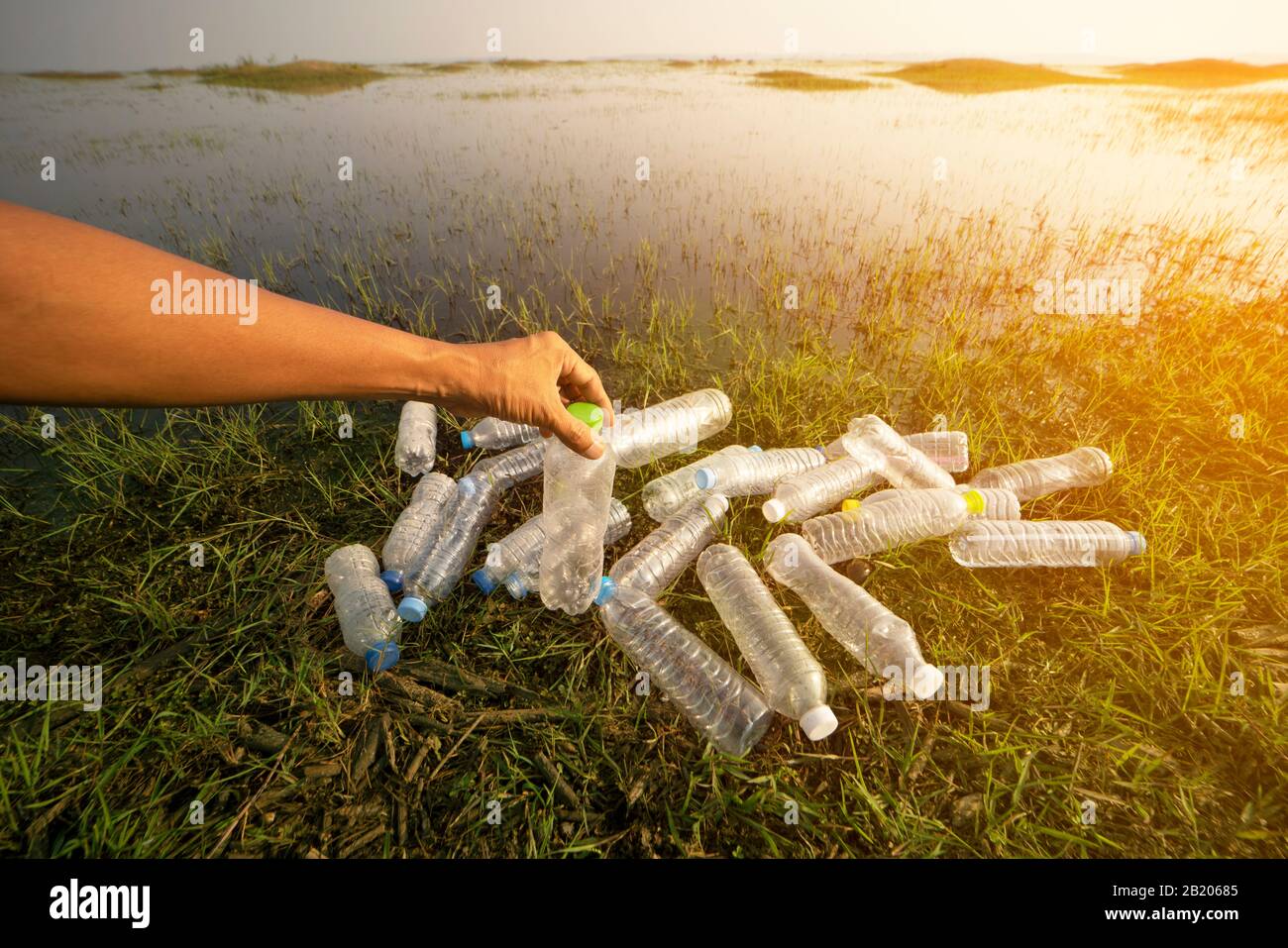 Close up hand picking up plastic bottle , Drought and environmental ...