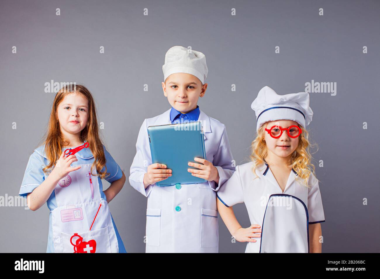 Kids imagine future profession. Cute little doctors on grey background ...