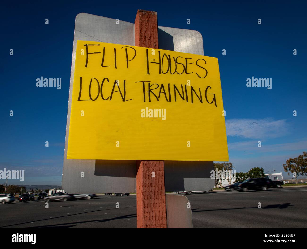 Yellow handwritten sign recruiting for getting rich quick by flipping ...