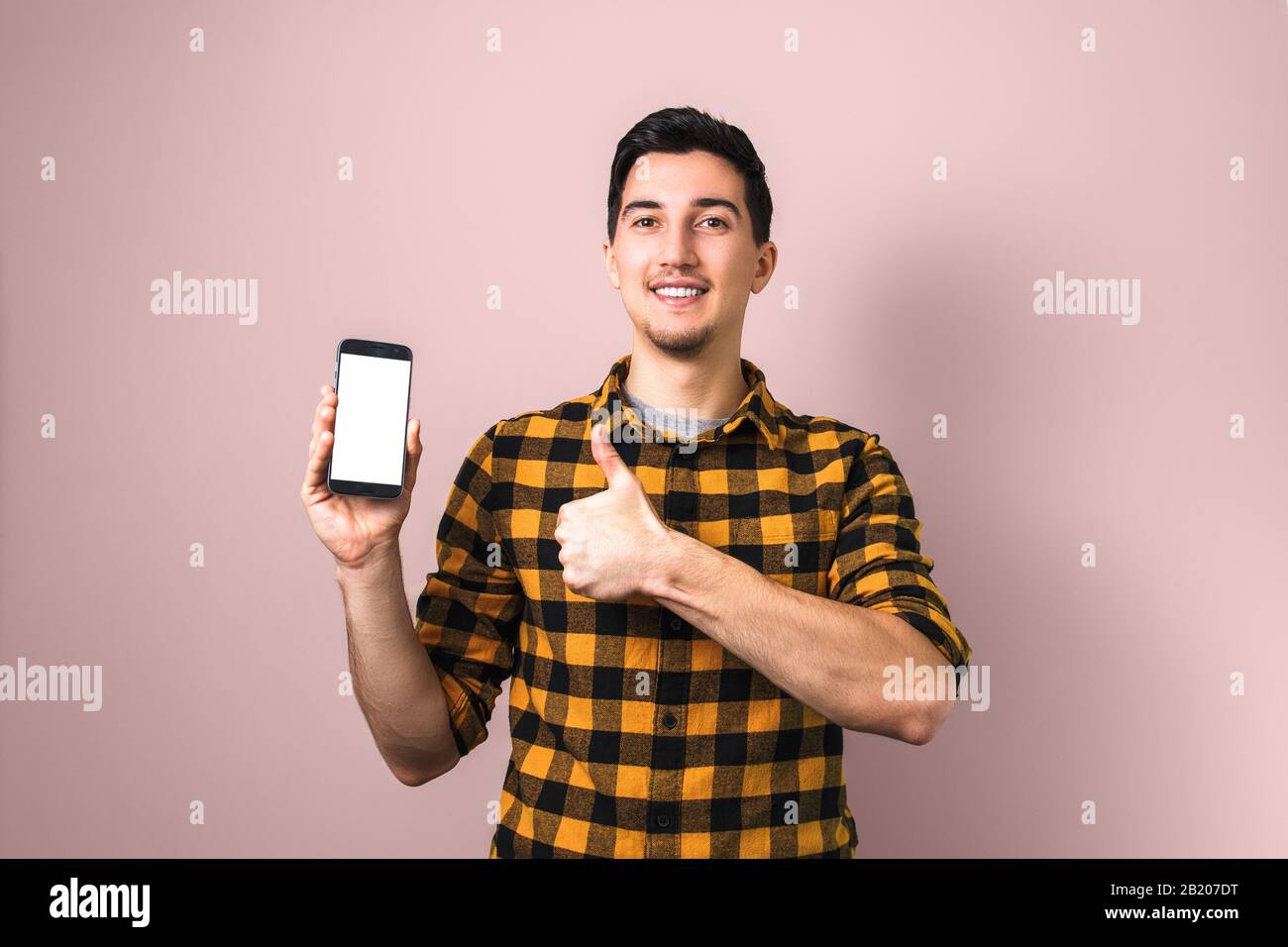 satisfied client. man holding a phone with white screen showing big ...