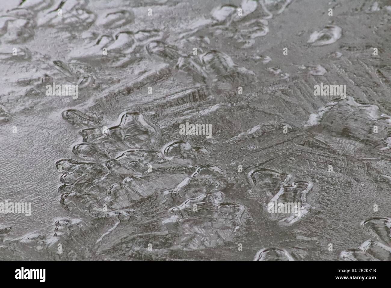 Patterns in ice on frozen pond Stock Photo - Alamy