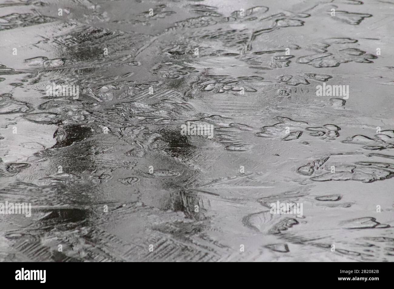 Patterns in ice on frozen pond Stock Photo - Alamy