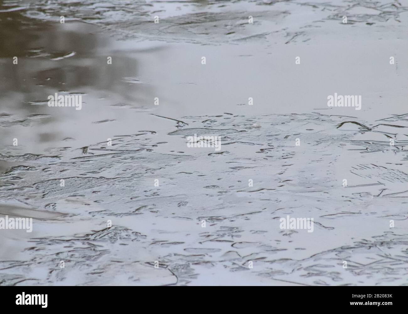 Patterns in ice on frozen pond Stock Photo - Alamy