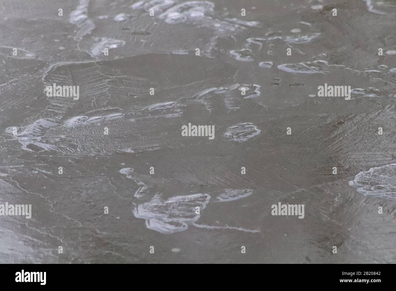 Patterns in ice on frozen pond Stock Photo - Alamy