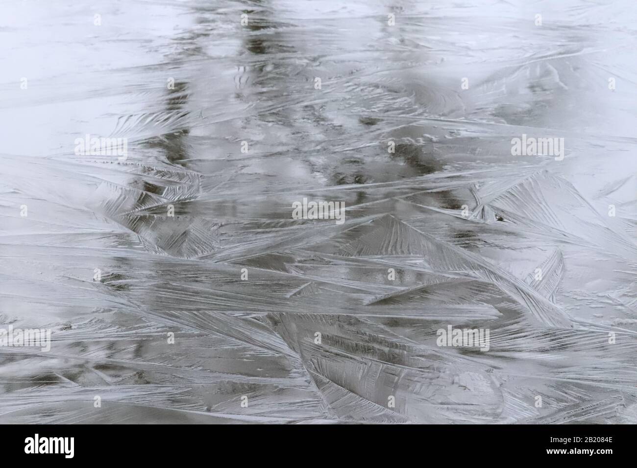 Patterns in ice on frozen pond Stock Photo - Alamy