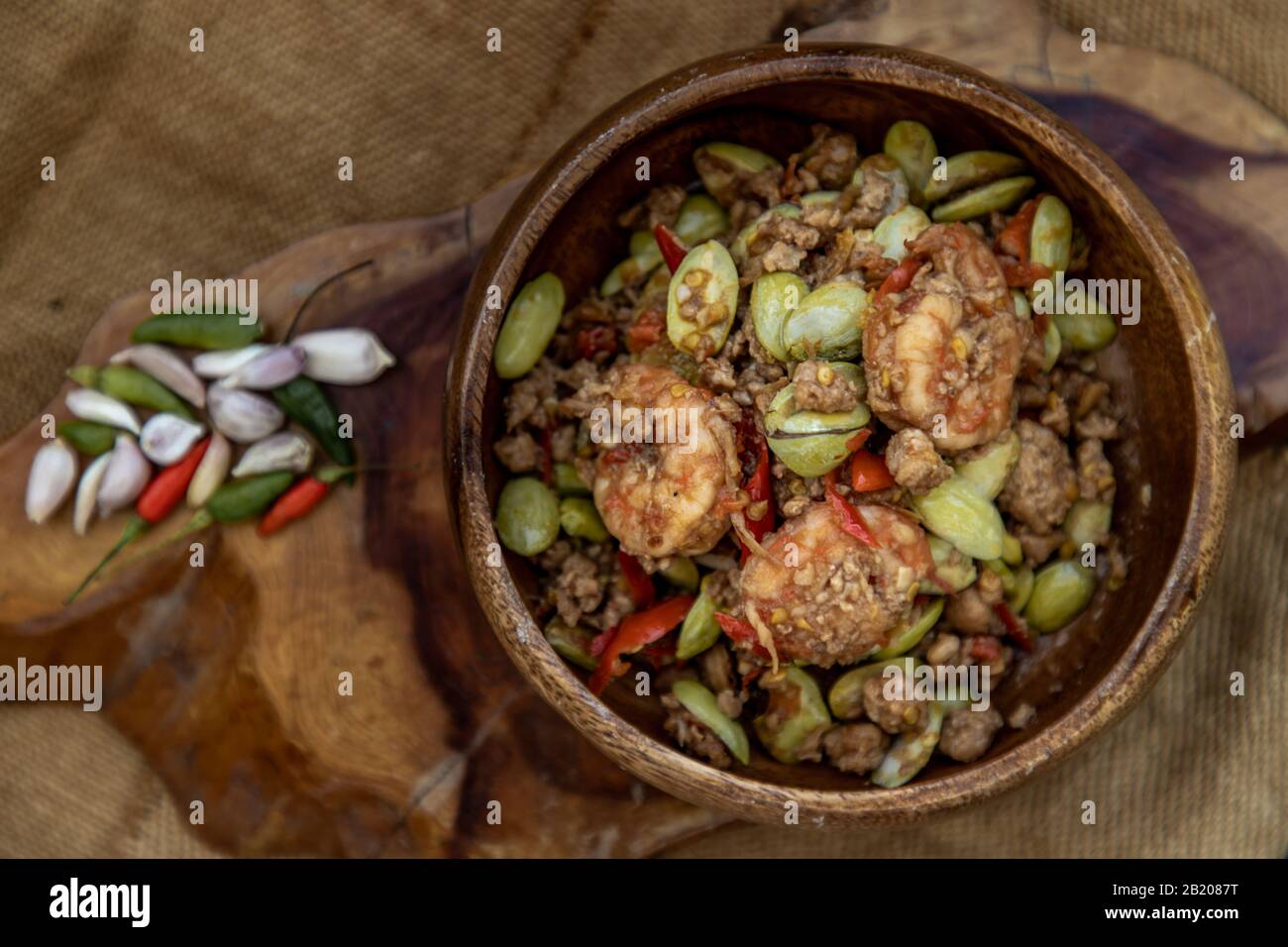 Stir Fried Bitter beans (Sator) with Shrimp in wooden bowl, It is a ...