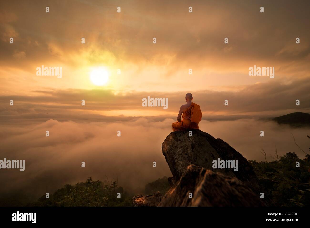 Buddhist monk in meditation at beautiful sunset or sunrise background ...