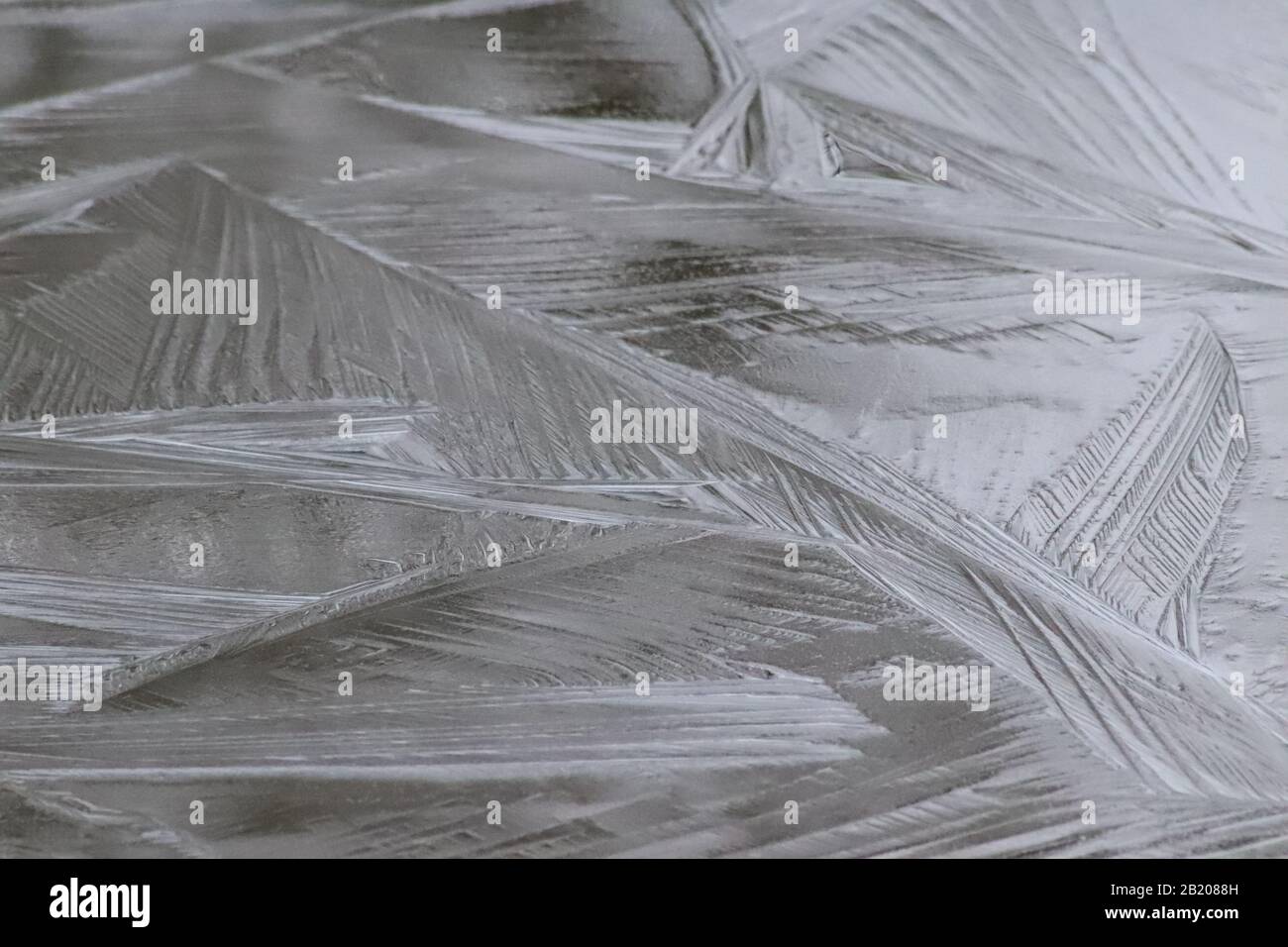 Ice patterns in frozen pond Stock Photo - Alamy