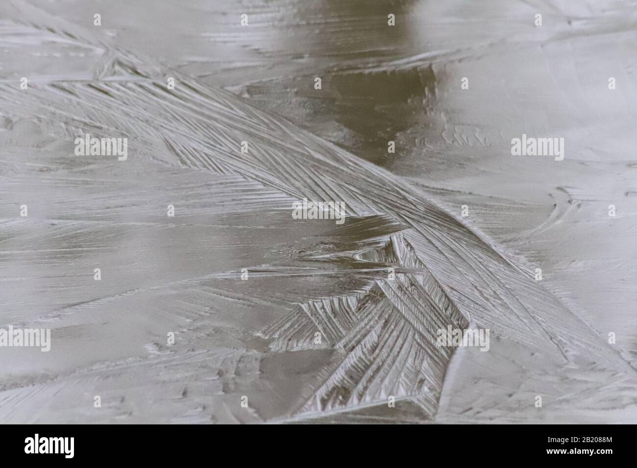 Ice patterns in frozen pond Stock Photo - Alamy