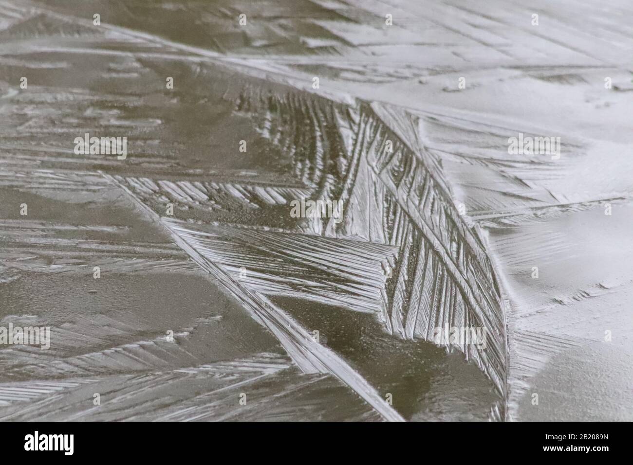 Ice patterns in frozen pond Stock Photo - Alamy