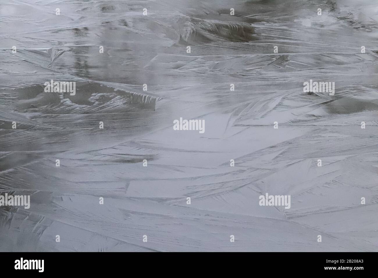 Ice patterns in frozen pond Stock Photo - Alamy