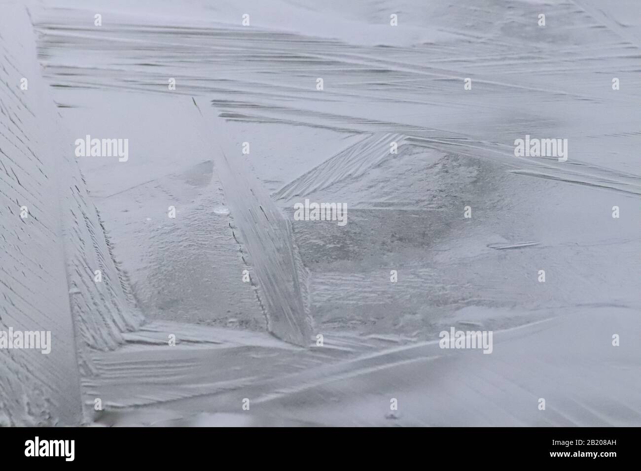 Ice patterns in frozen pond Stock Photo - Alamy