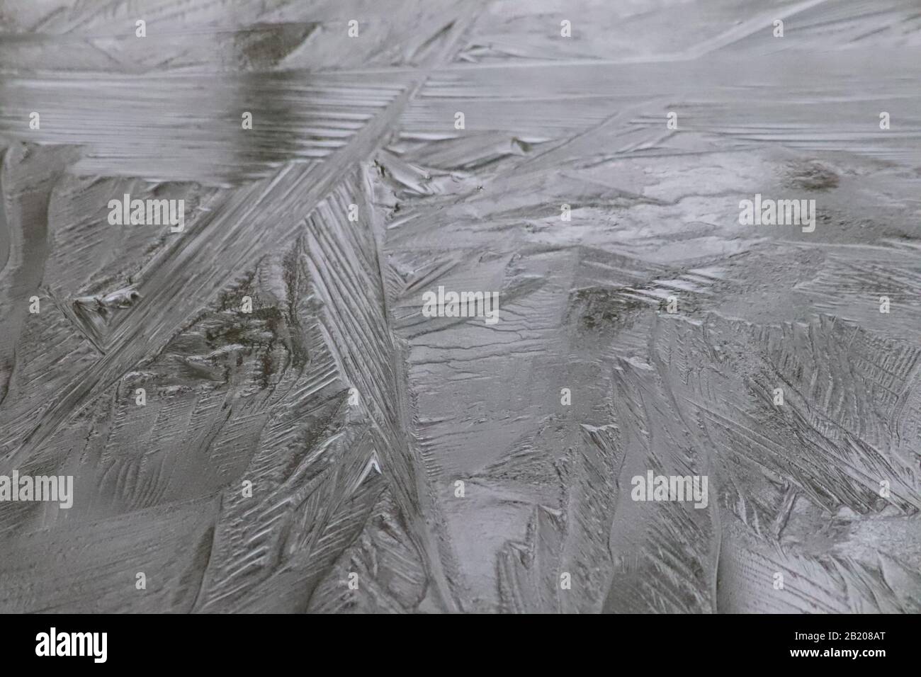 Ice patterns in frozen pond Stock Photo - Alamy