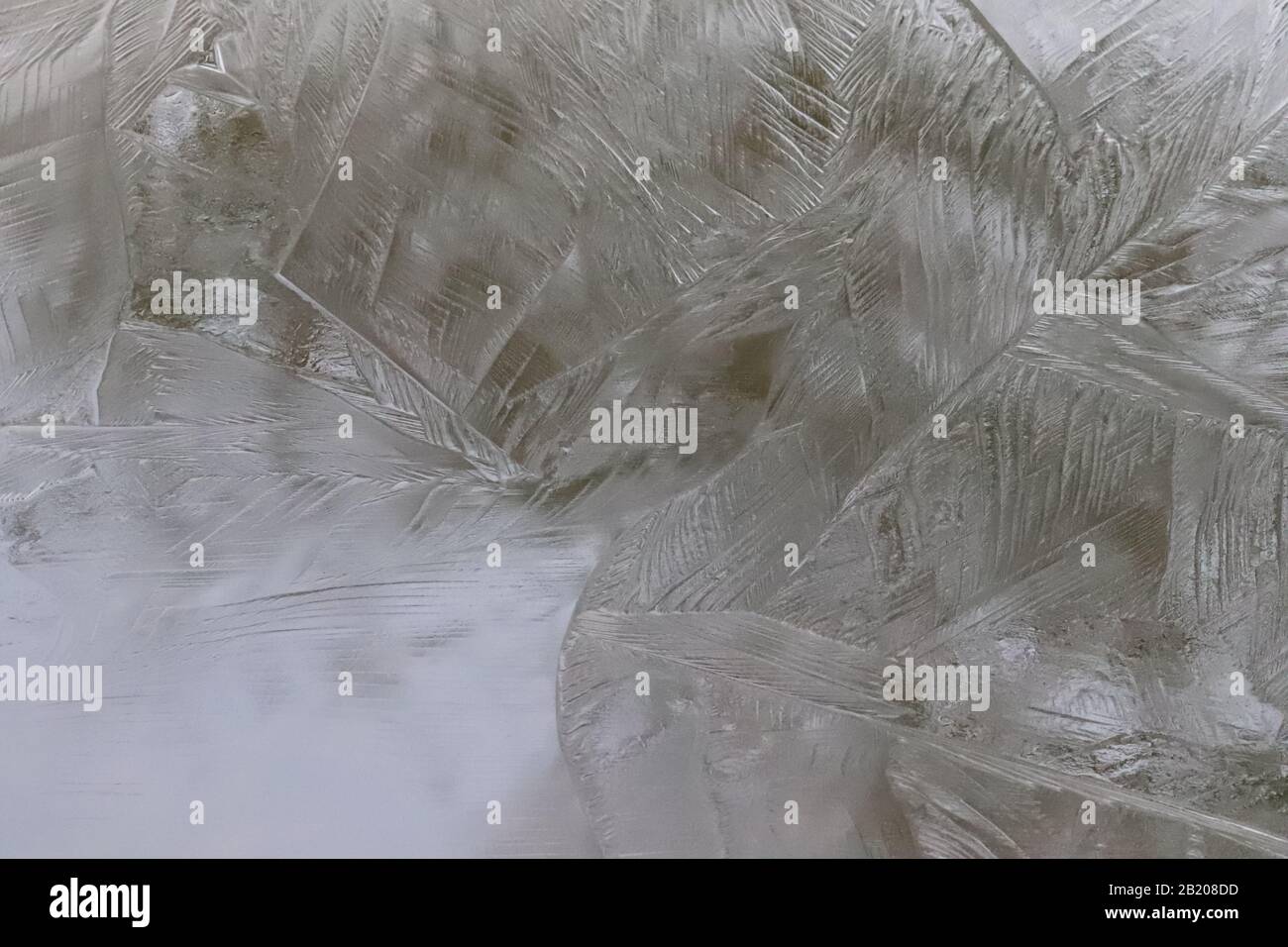 Ice patterns in frozen pond Stock Photo - Alamy