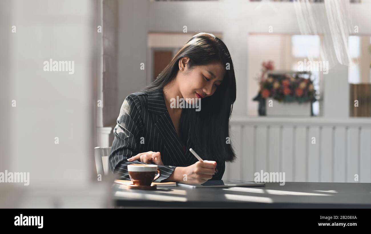 Photo of young executive woman in black striped suit drawing business ...